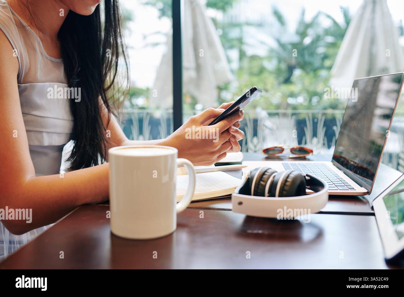 Female freelancer answering messages on social media when working at ...