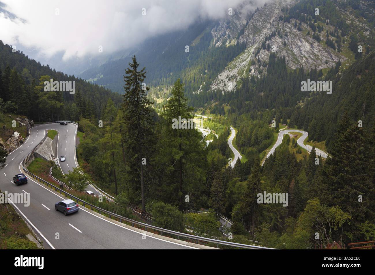 Cars on a steep mountain road turn in the Italian Alps Stock Photo - Alamy
