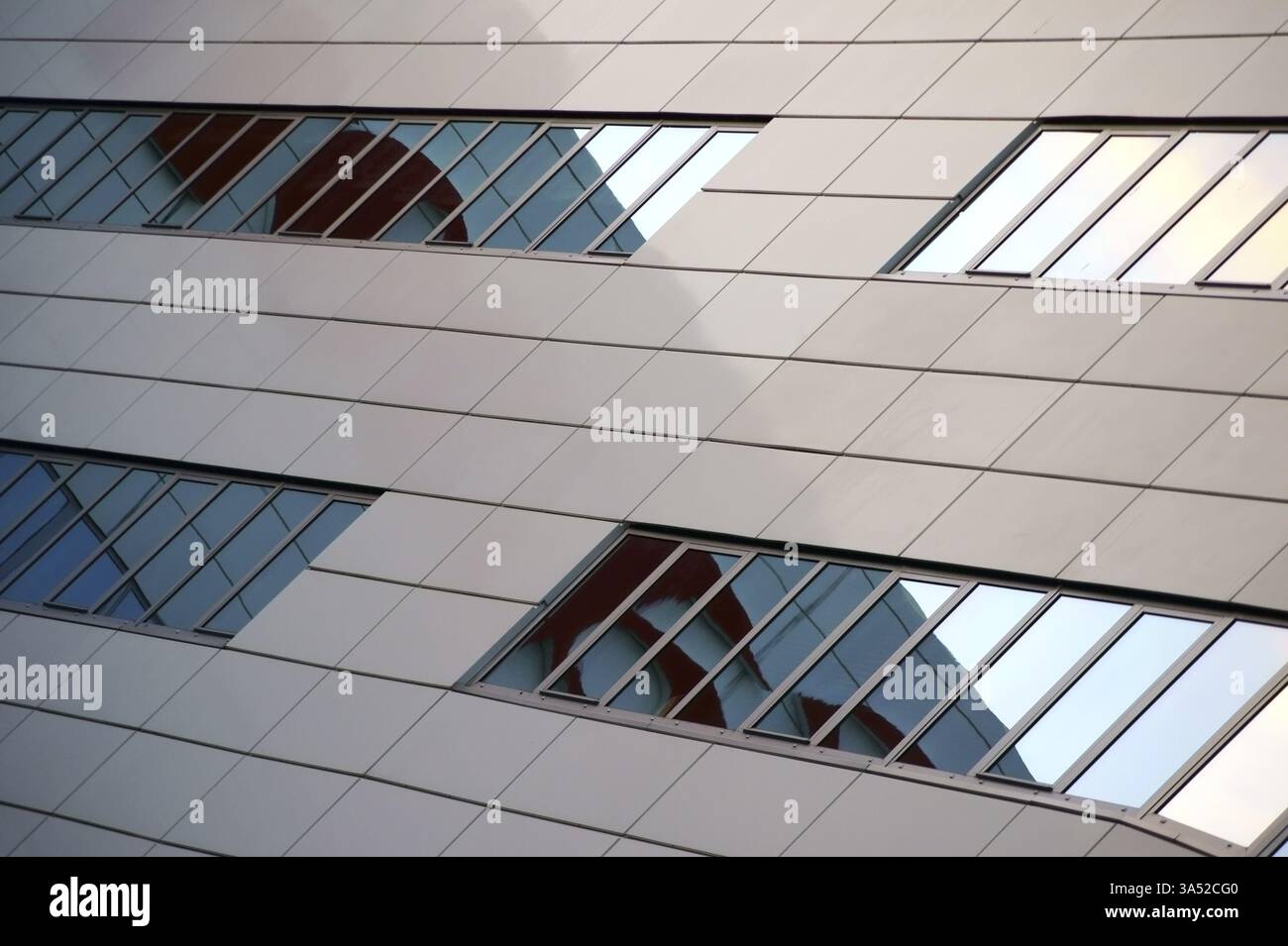 The modern rows of windows and facade panelling of an office and ...