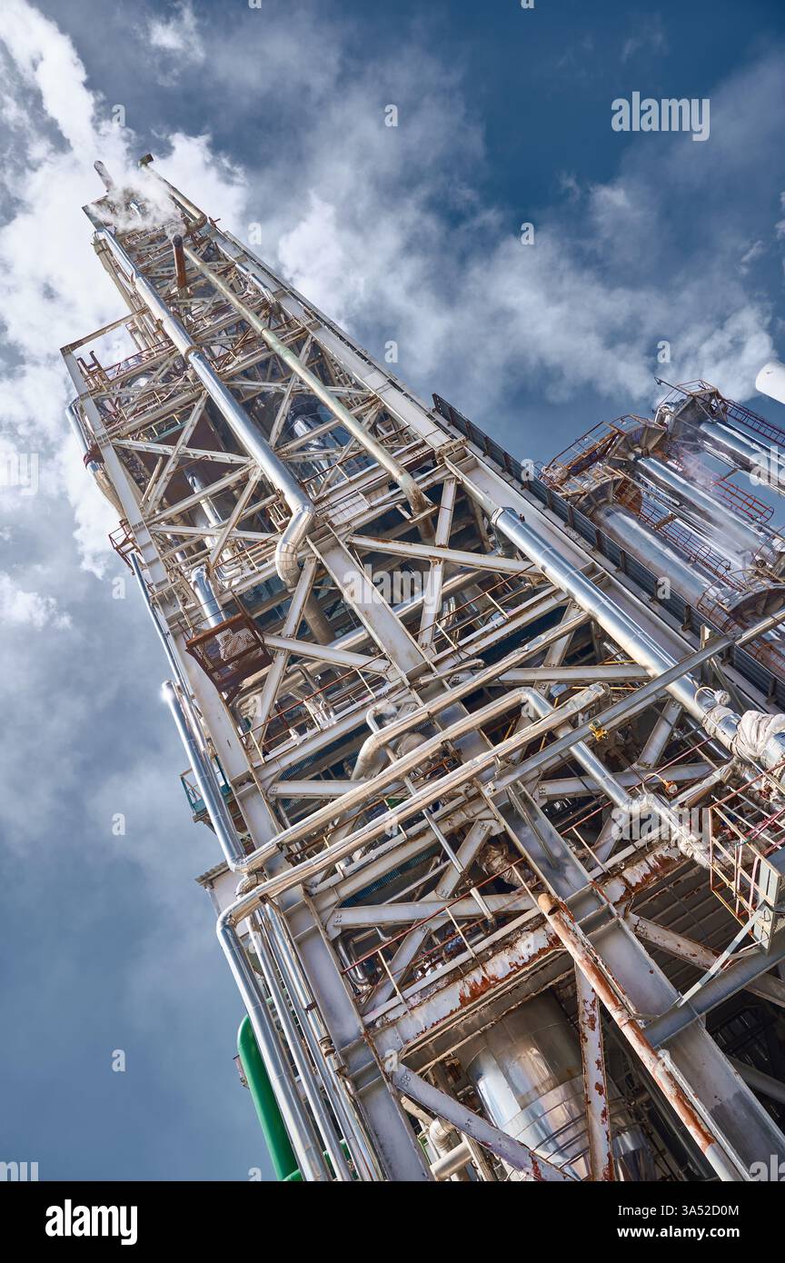 Industrial chemical plant with towering structures under a clear sky ...