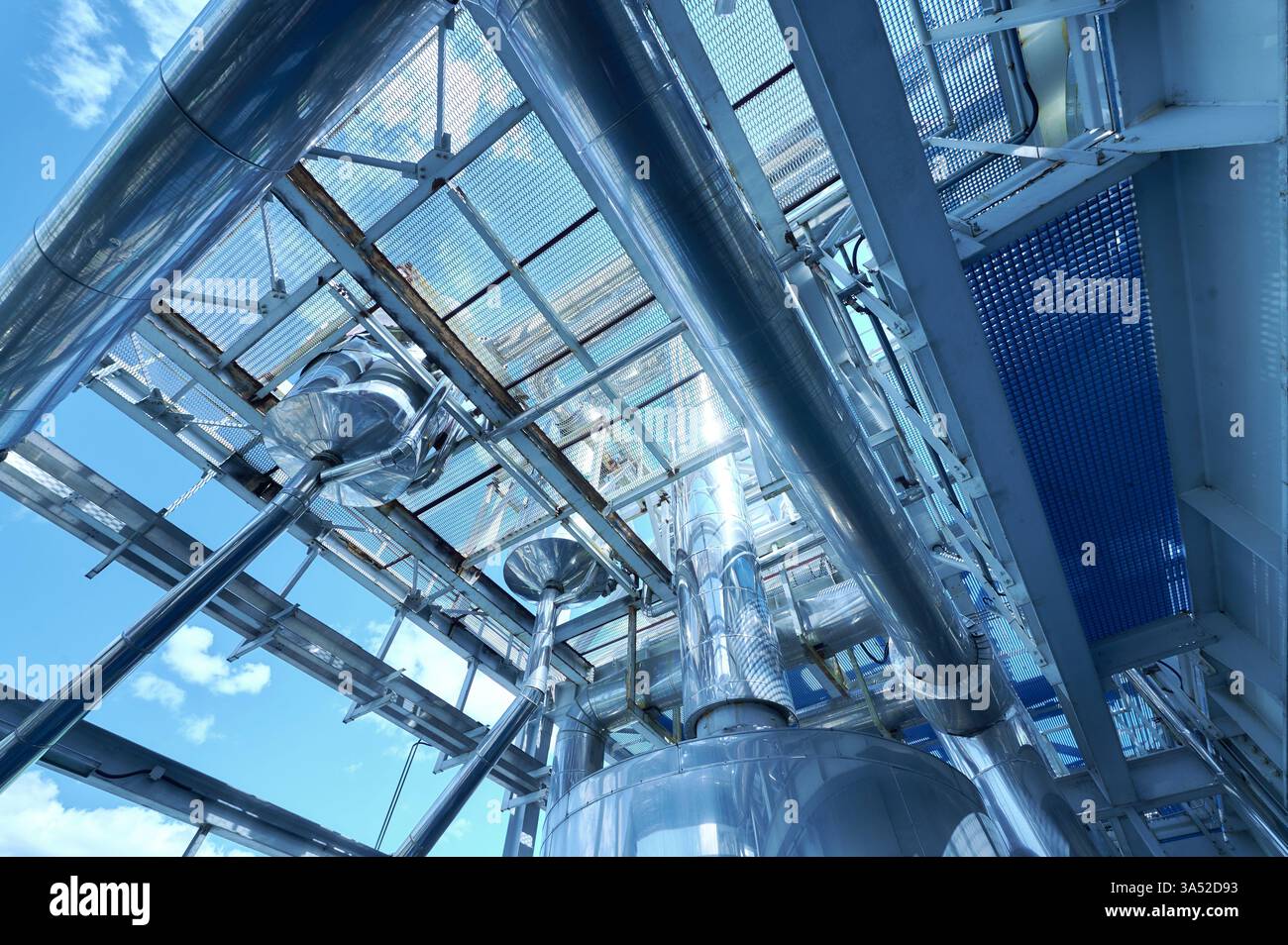 Pipelines and structures in a chemical plant under a clear blue sky ...