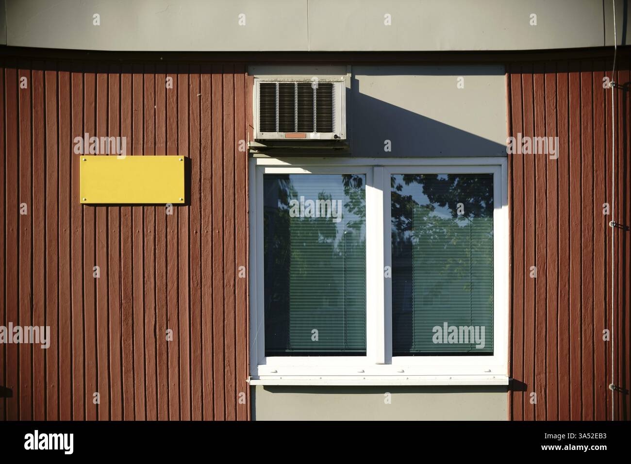 A wooden barrack with plank walls is equipped with a window and ...
