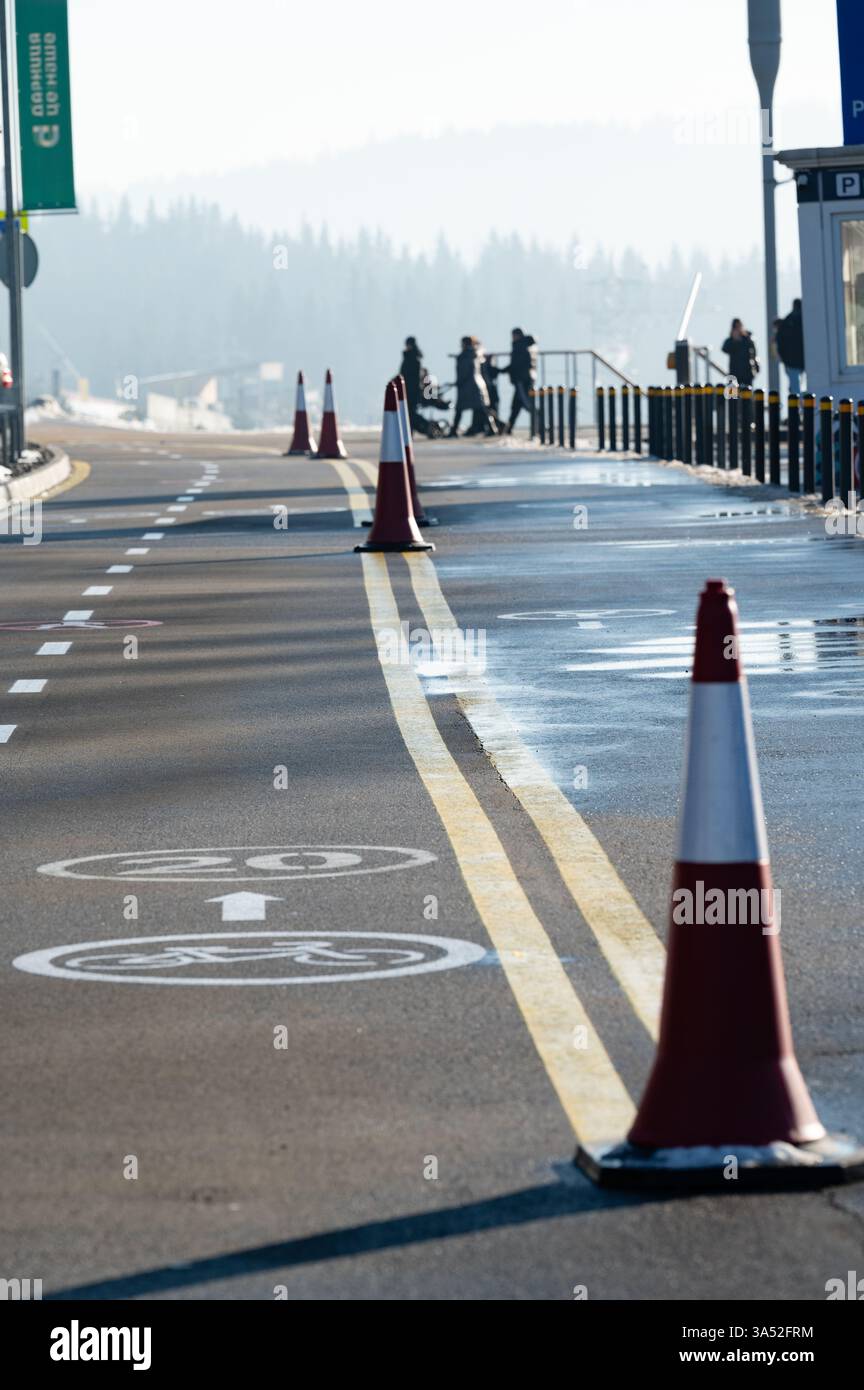 Traffic cones guide pedestrians and cyclists along a peaceful avenue ...