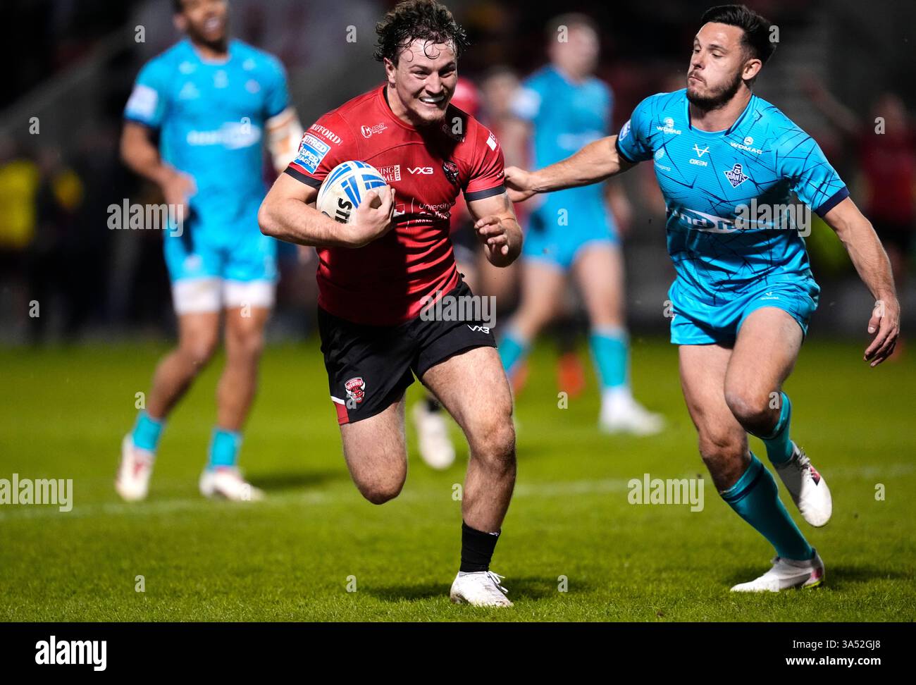 Salford Red Devils' Harvey Wilson on his way to scoring his side's ...