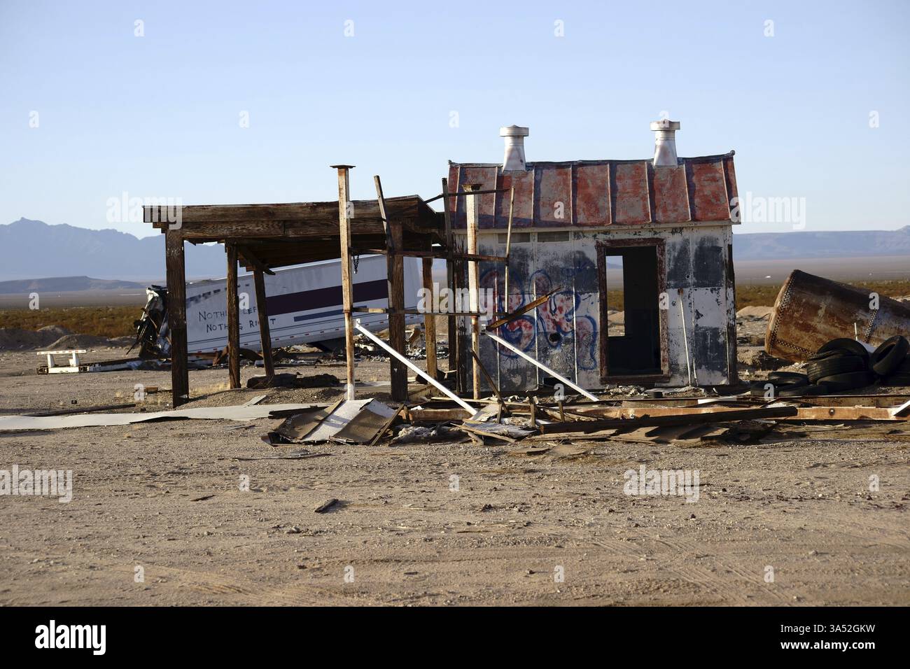 Dilapidated wooden huts, camping trailers and rusty water tanks in the ...