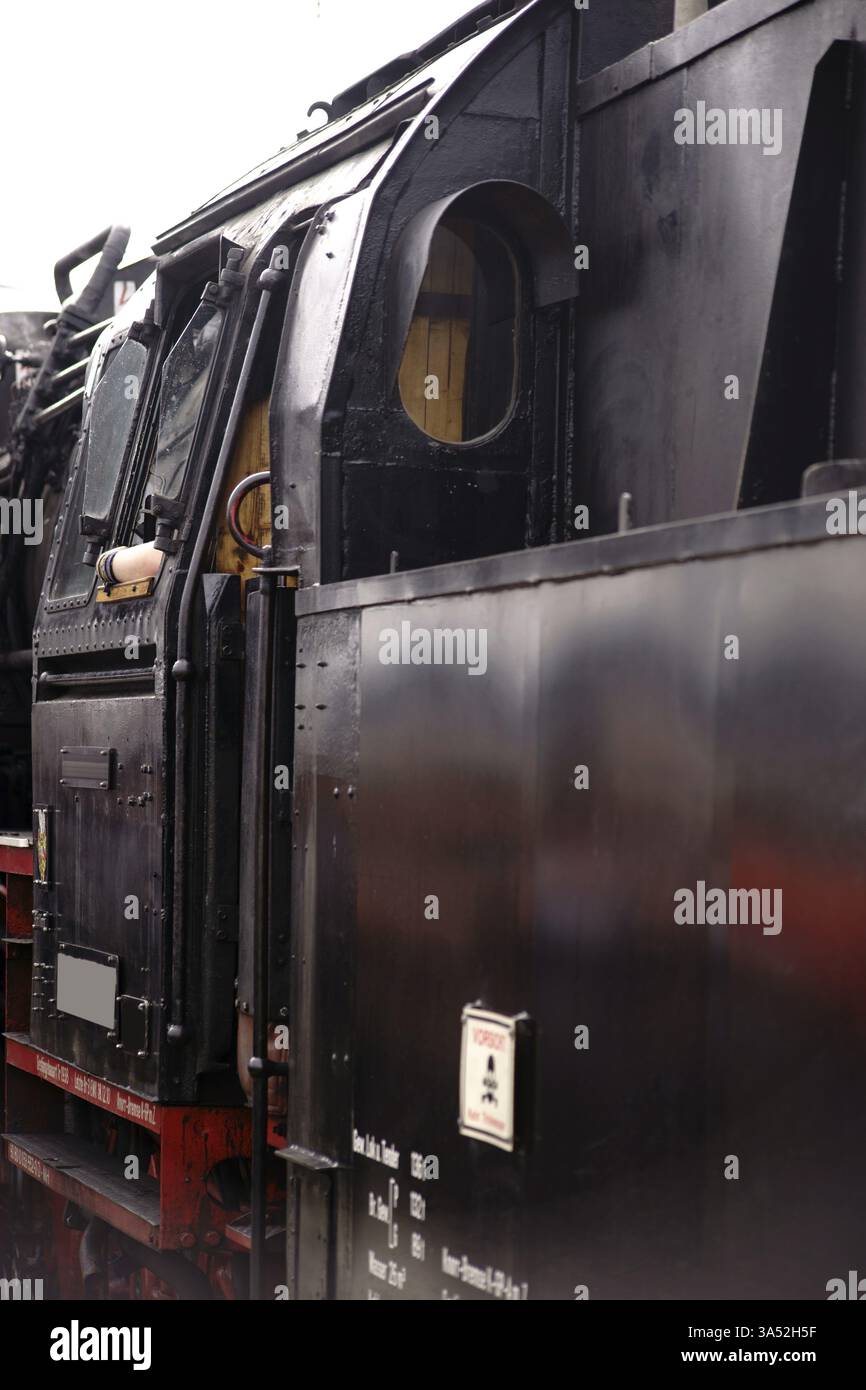 The side view and driver's cab of an old steam locomotive with coal to ...