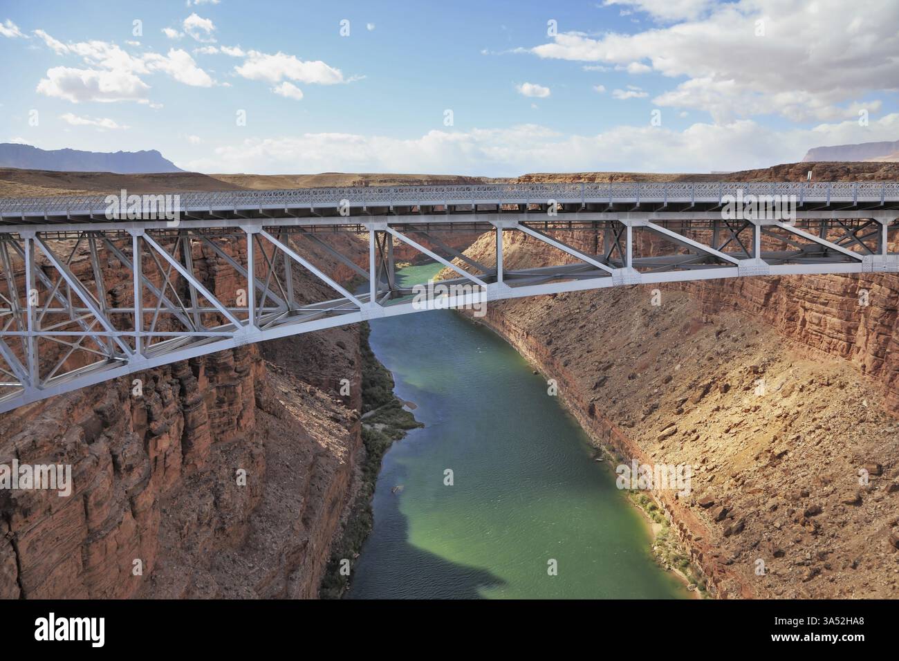 The easy metal bridge through the river Colorado in abrupt coast of ...