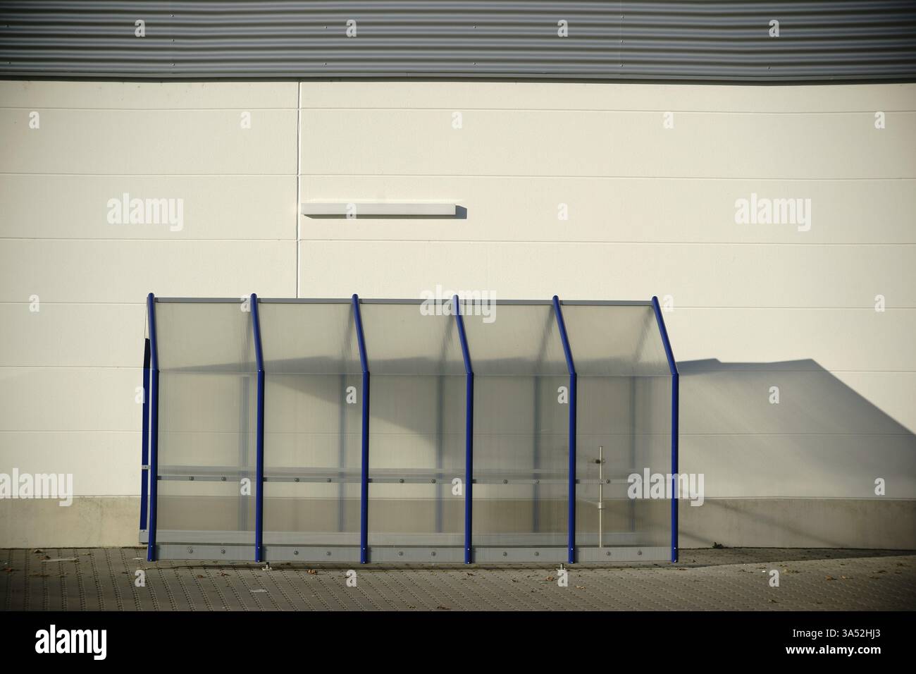 An empty plastic shelter for shopping baskets on the wall of a shopping ...