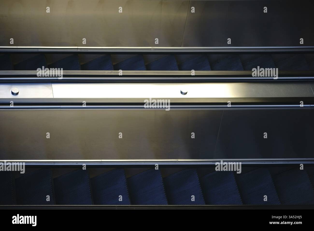 Top view of a modern escalator with a railing made of metal walls Stock ...