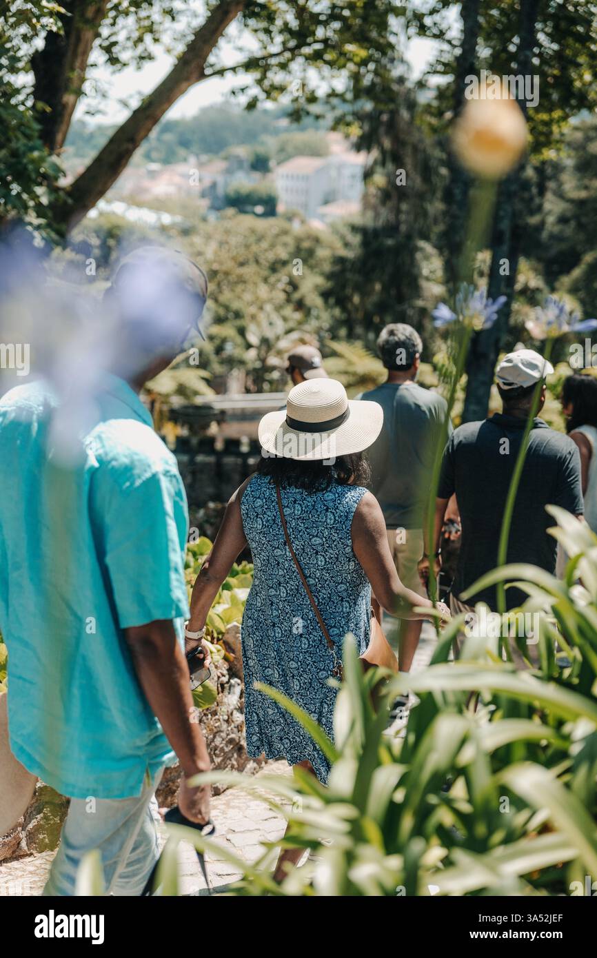 People walking down through sunny forest grounds in Sintra, Portugal ...