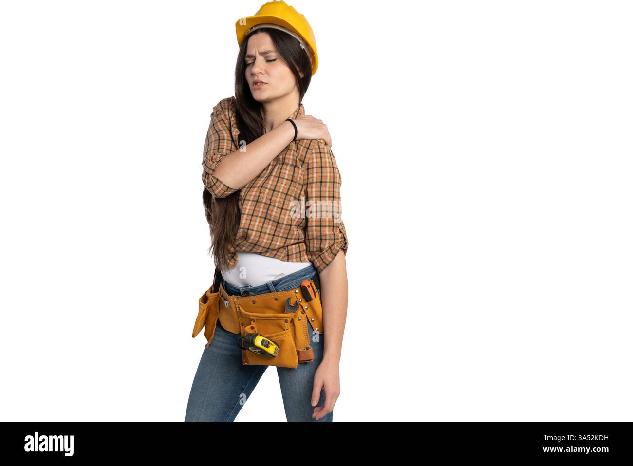 A female construction worker wearing a yellow hard hat and tool belt ...