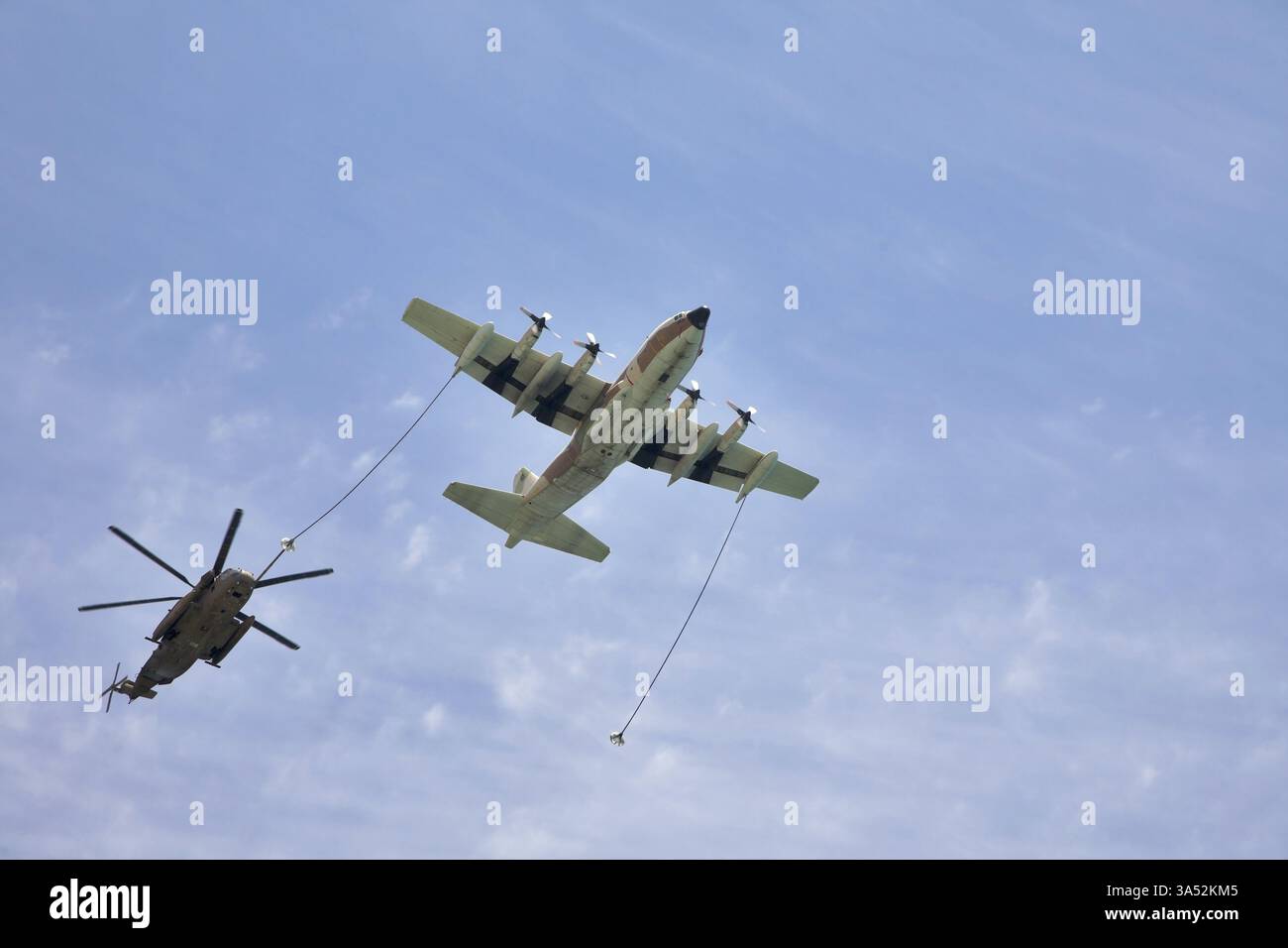 Refuelling in air is made with the plane and helicopter on celebratory ...