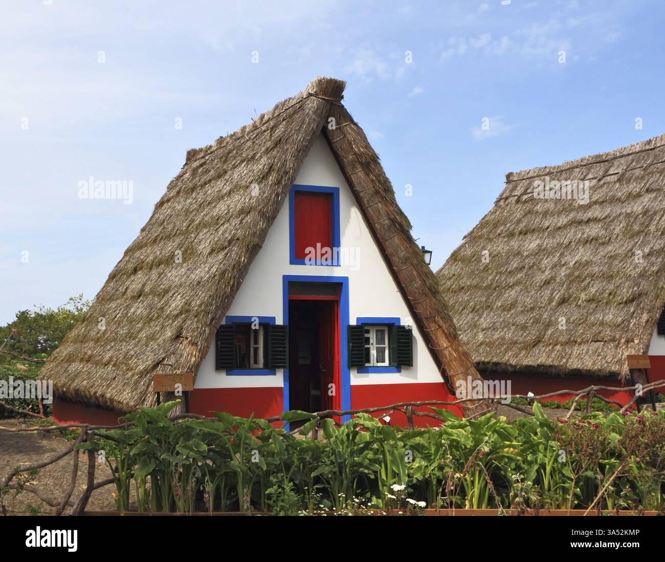 Pastoral landscape. Cosy chalet with a triangular thatched roof. Before ...