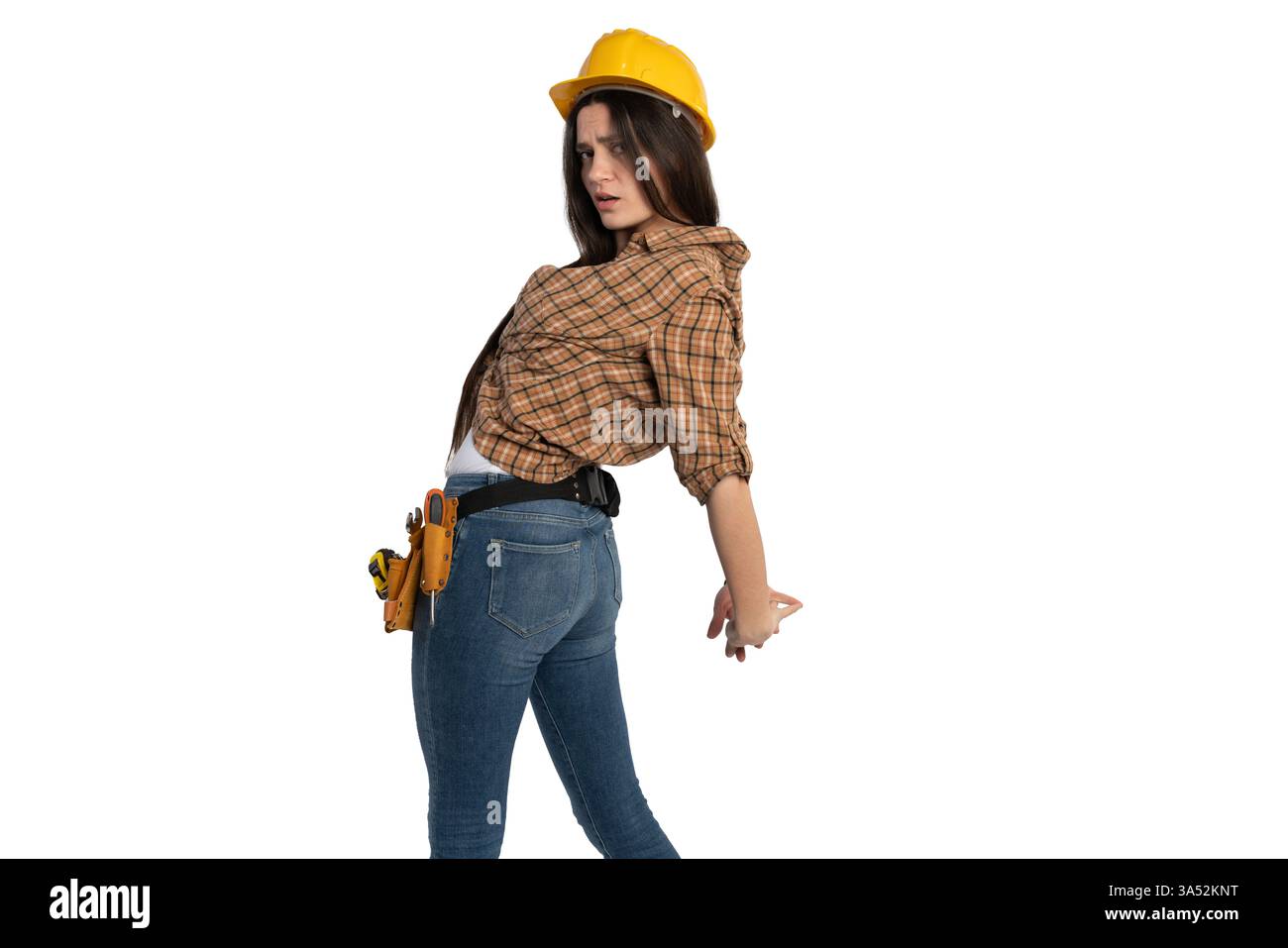 A female construction worker wearing a yellow hard hat and tool belt ...