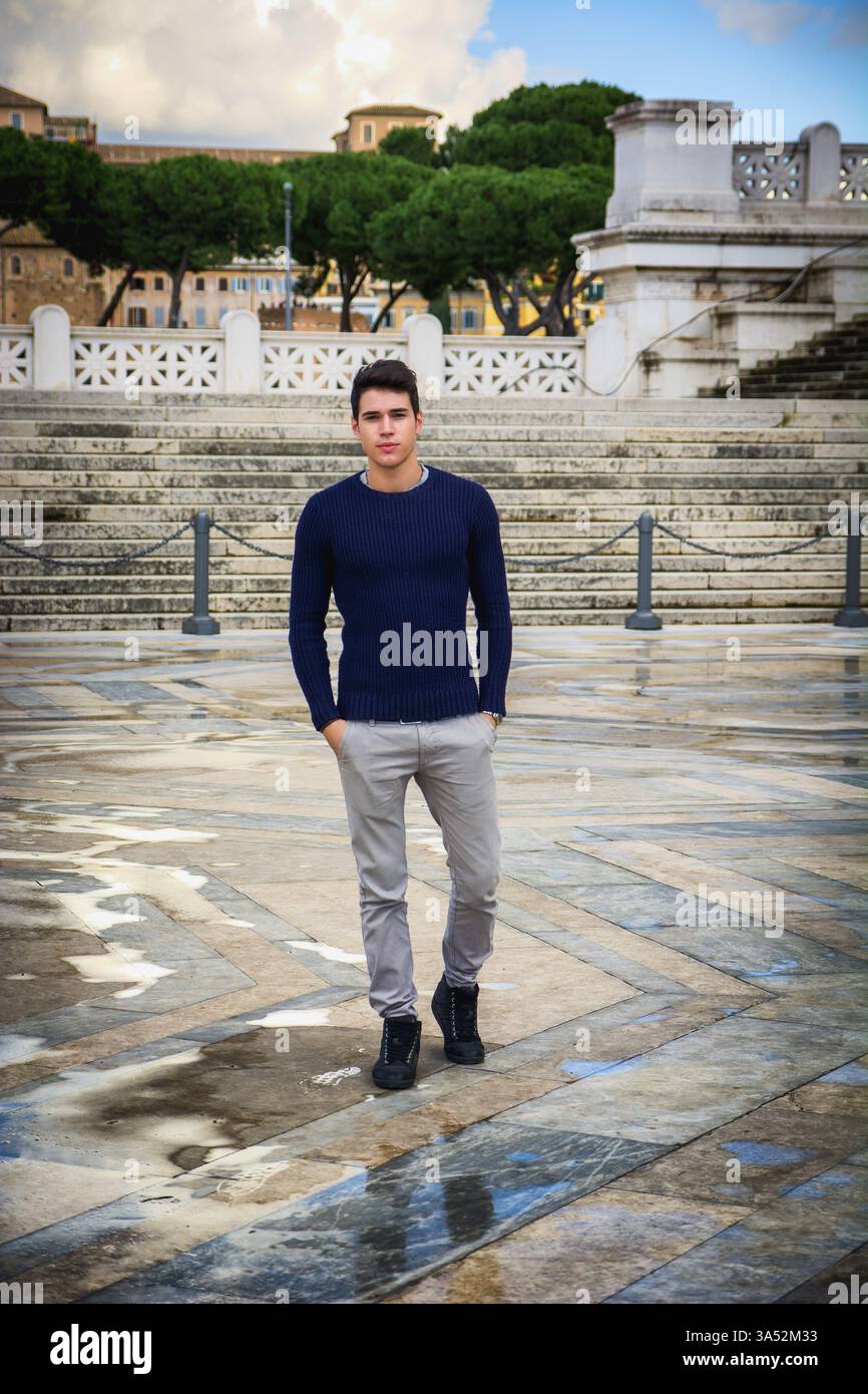 Attractive young man in Rome in front of Vittoriano monument standing ...
