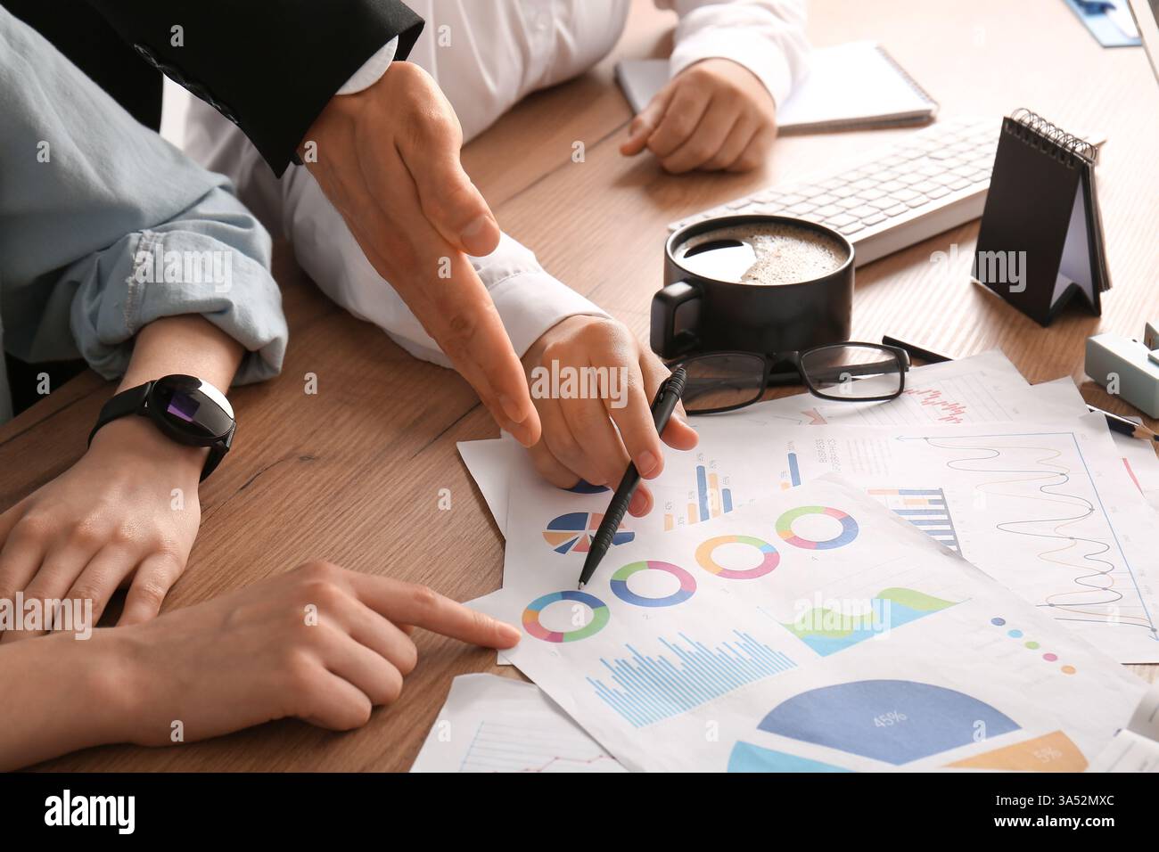Business team working with diagrams during meeting in office, closeup ...