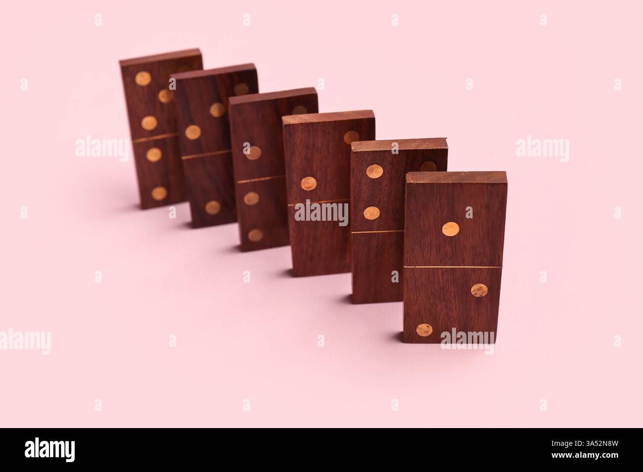Wooden dominos blocks on pink background Stock Photo - Alamy
