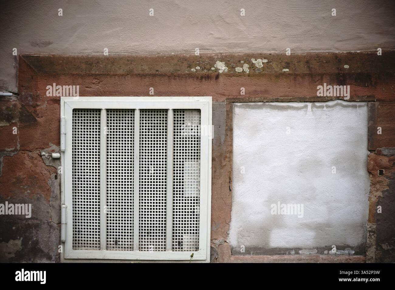 A cellar hatch with a grille and a bricked-up cellar hatch on a house ...
