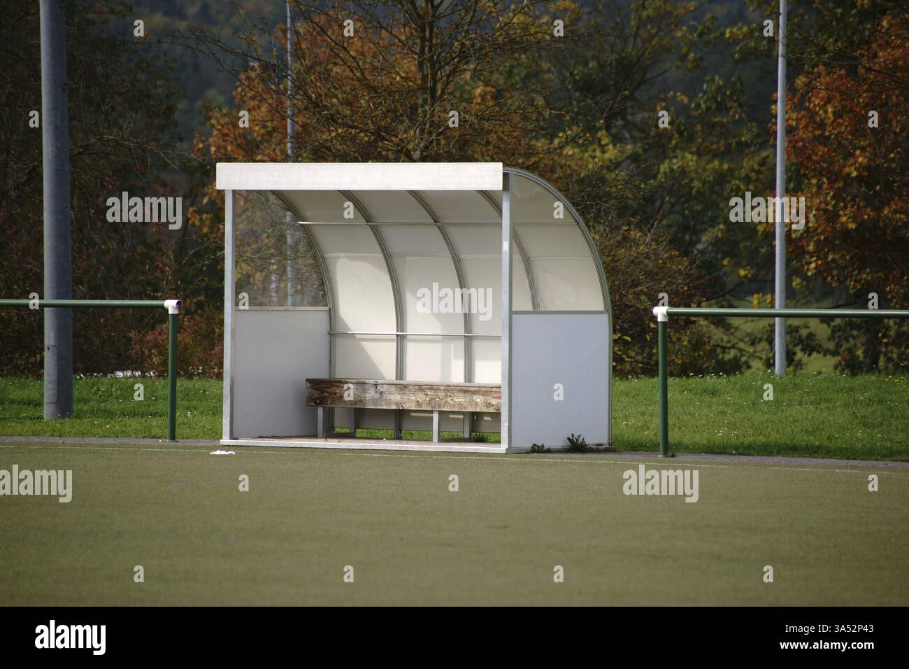 A trainer's bench stands at the edge of a football pitch in a football ...