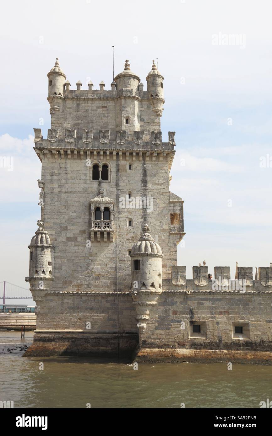 The famous Tower of Belem in the water of the river Tagus. White marble ...