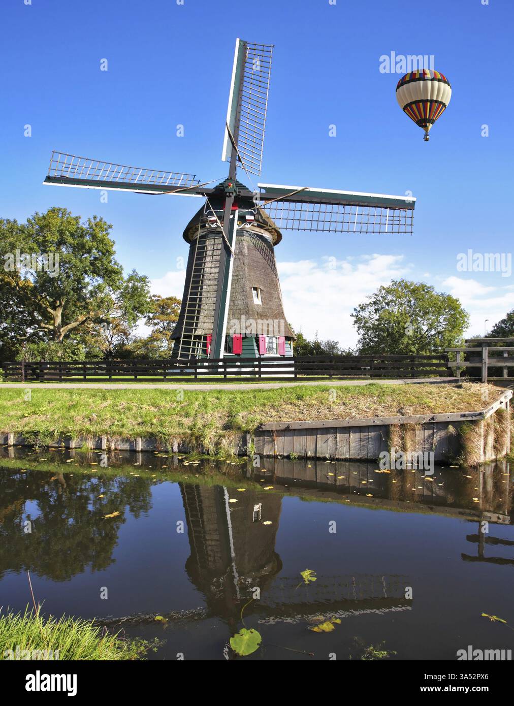 Over the windmills in the sky flying a giant balloon. The bright summer ...