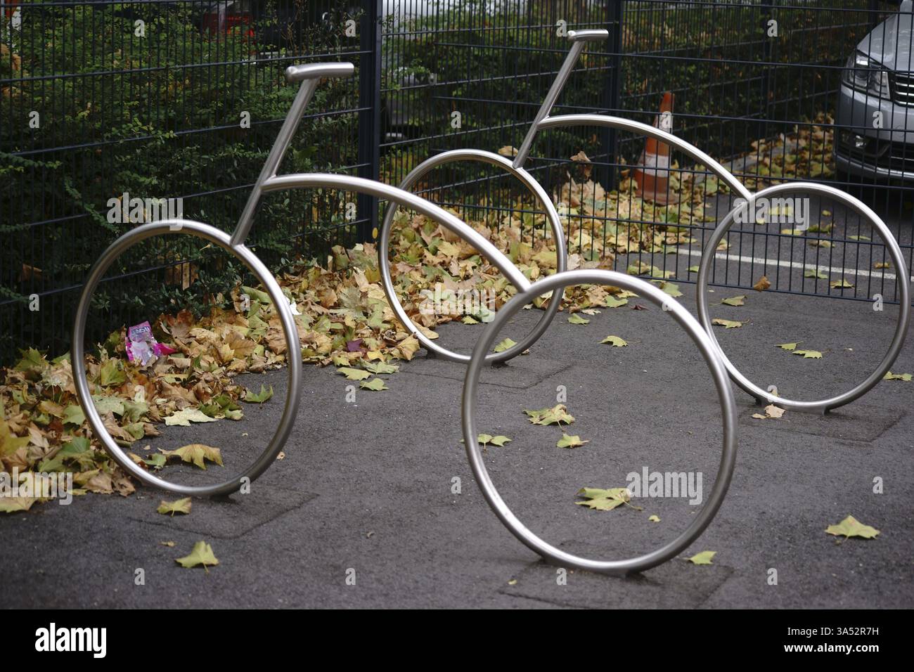 Abstract stainless steel bicycle racks arranged in a row have the shape ...