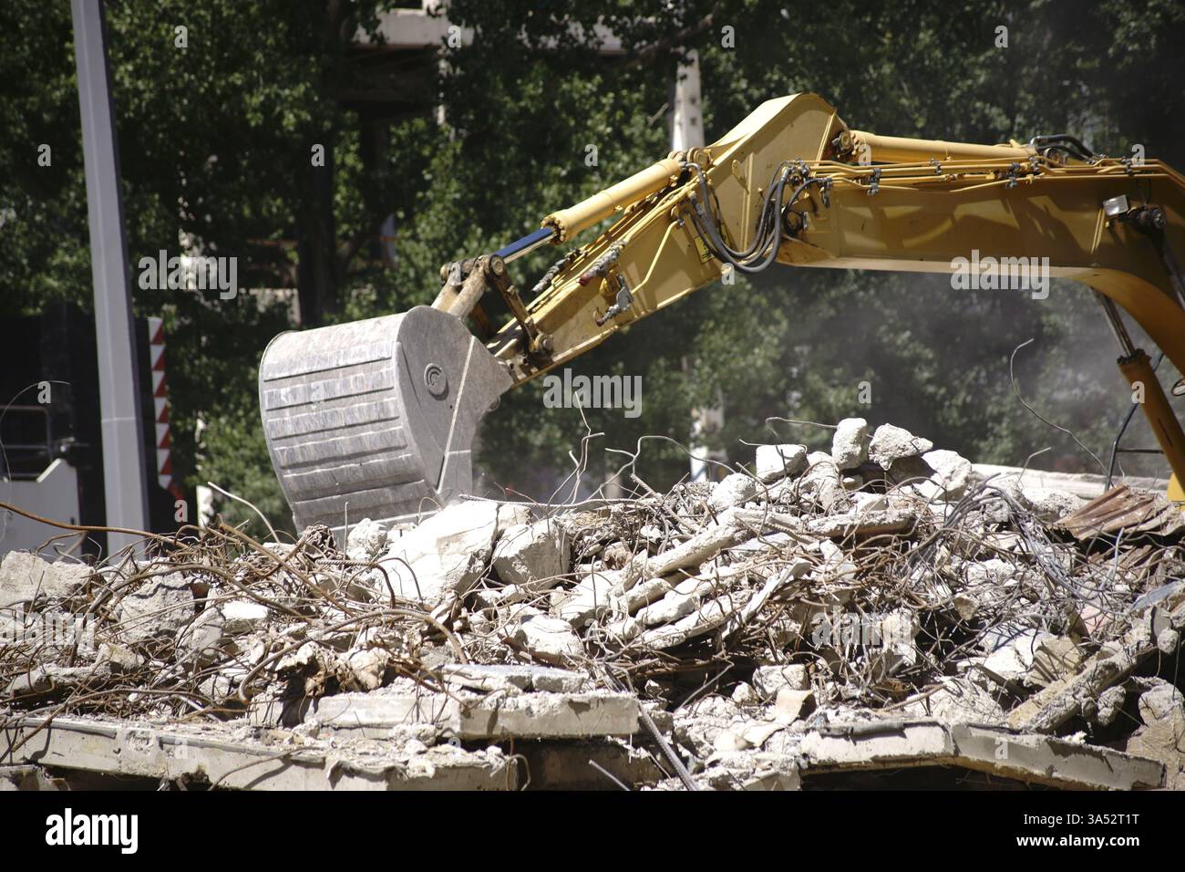 An excavator stands at the construction site of an industrial building ...