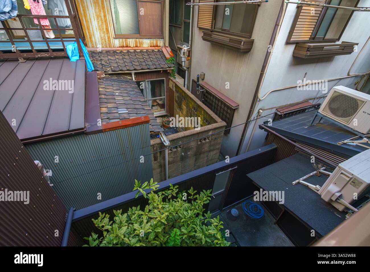 Osaka, Japan - Sep 25 2024, panoramic view of narrow well courtyard with balconies facing it and ...