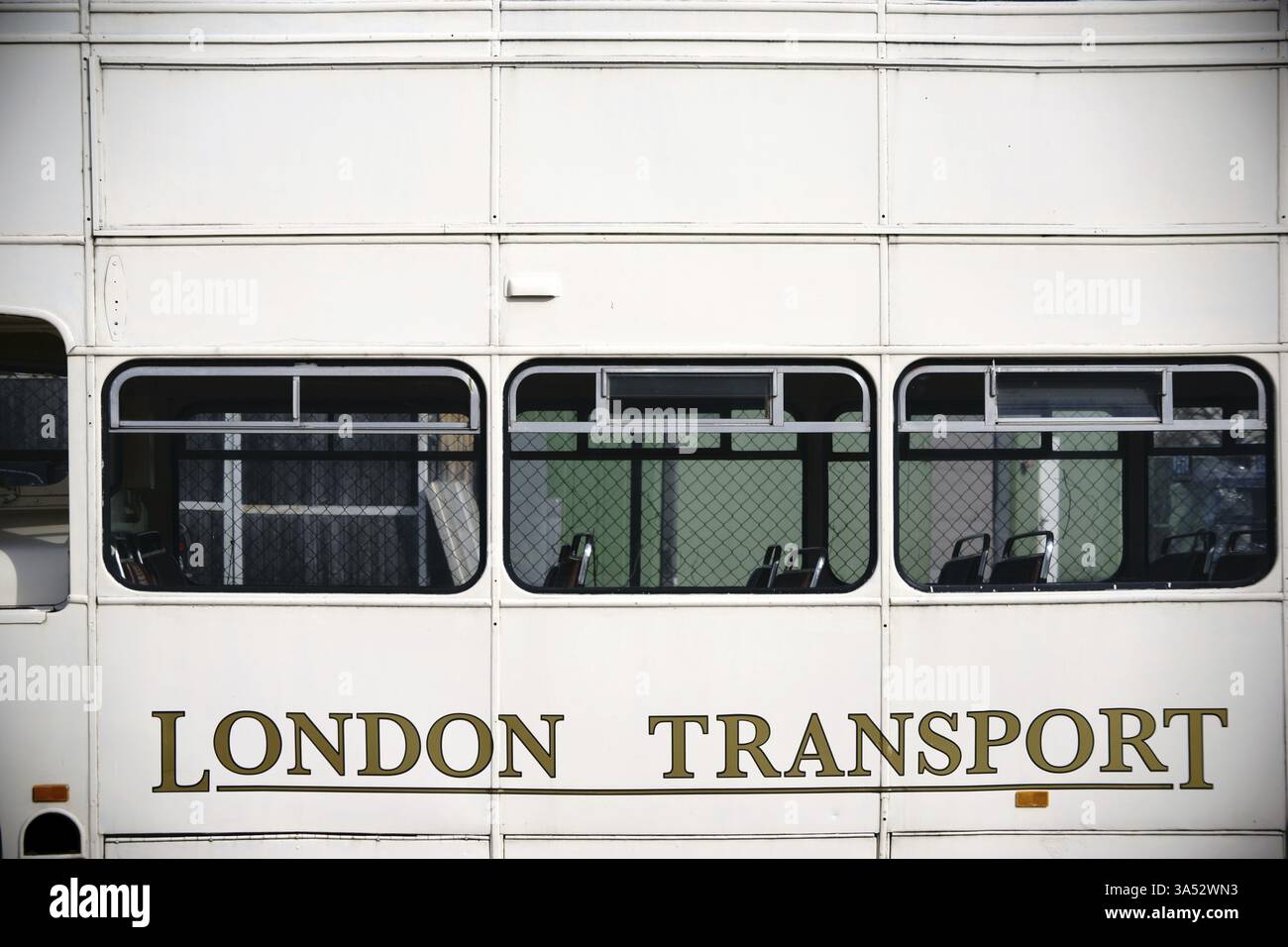 The side view of the lower rows of seats on an old double-decker bus ...