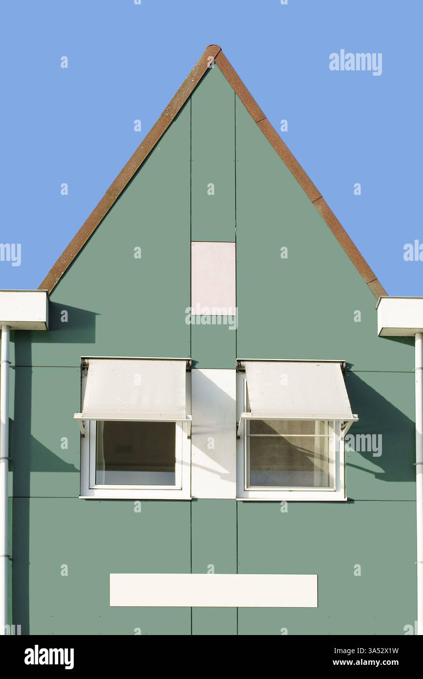 A Dutch house with a triangular roof gable, rain gutters and sun ...