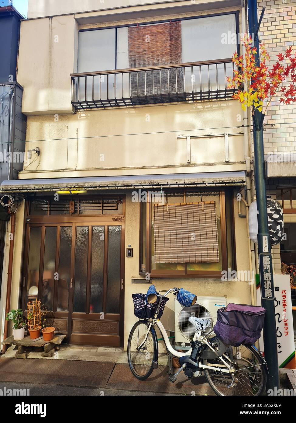 Small old building in Asakusa, Tokyo, Japan with a bicycle parked in ...