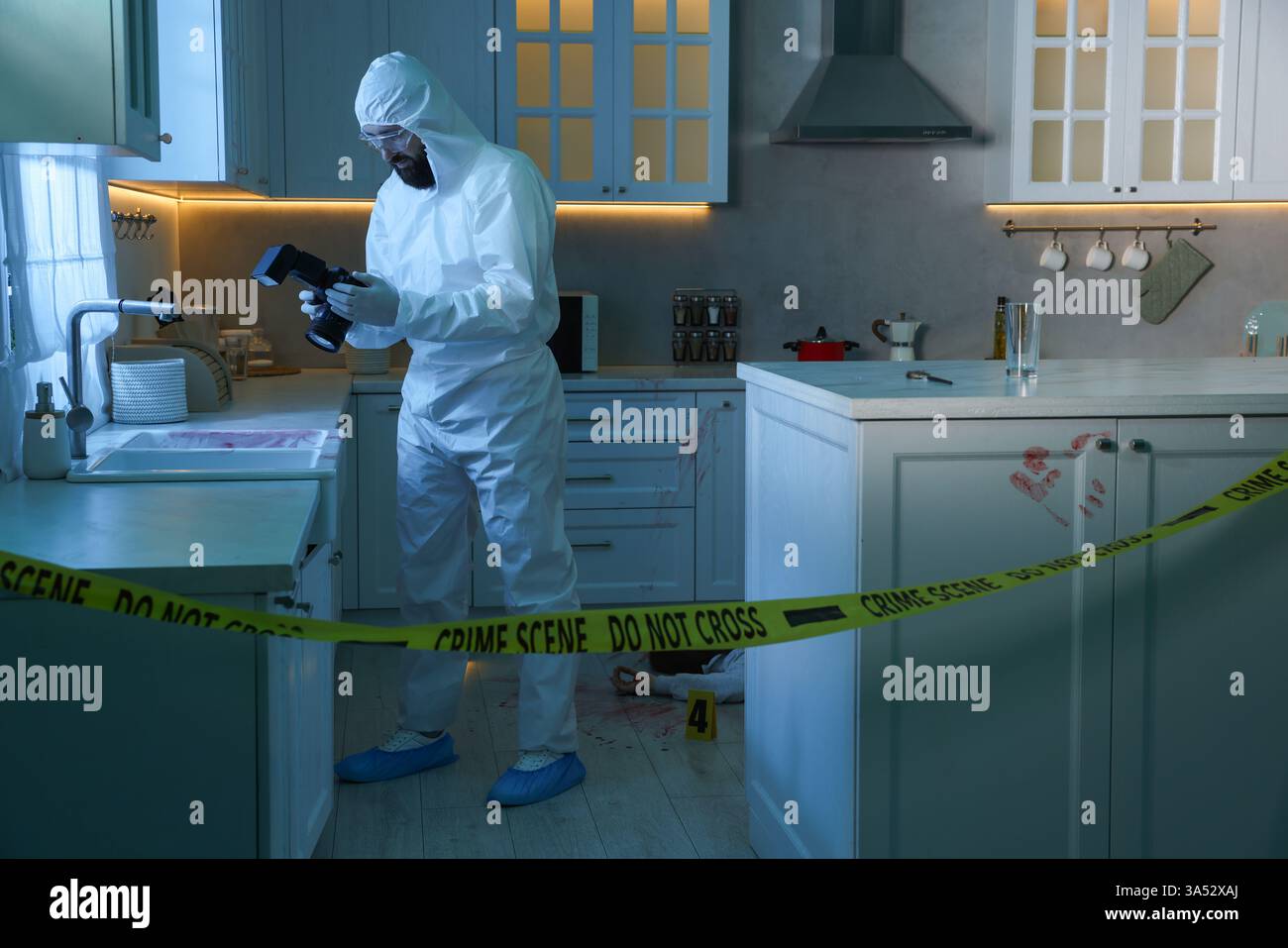 Forensic expert with camera working at crime scene in dark room Stock ...