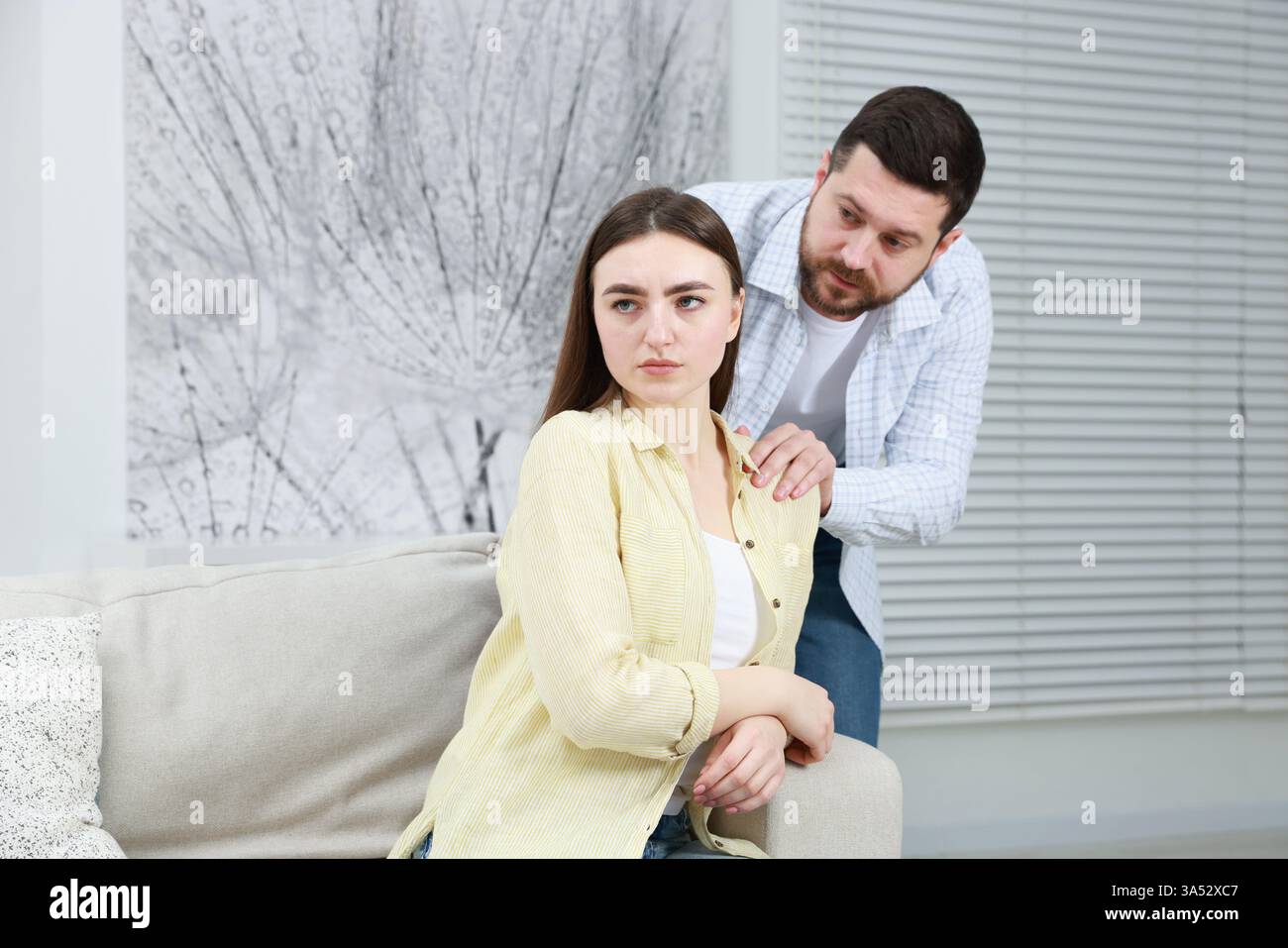 Man comforting his resentful girlfriend at home Stock Photo - Alamy
