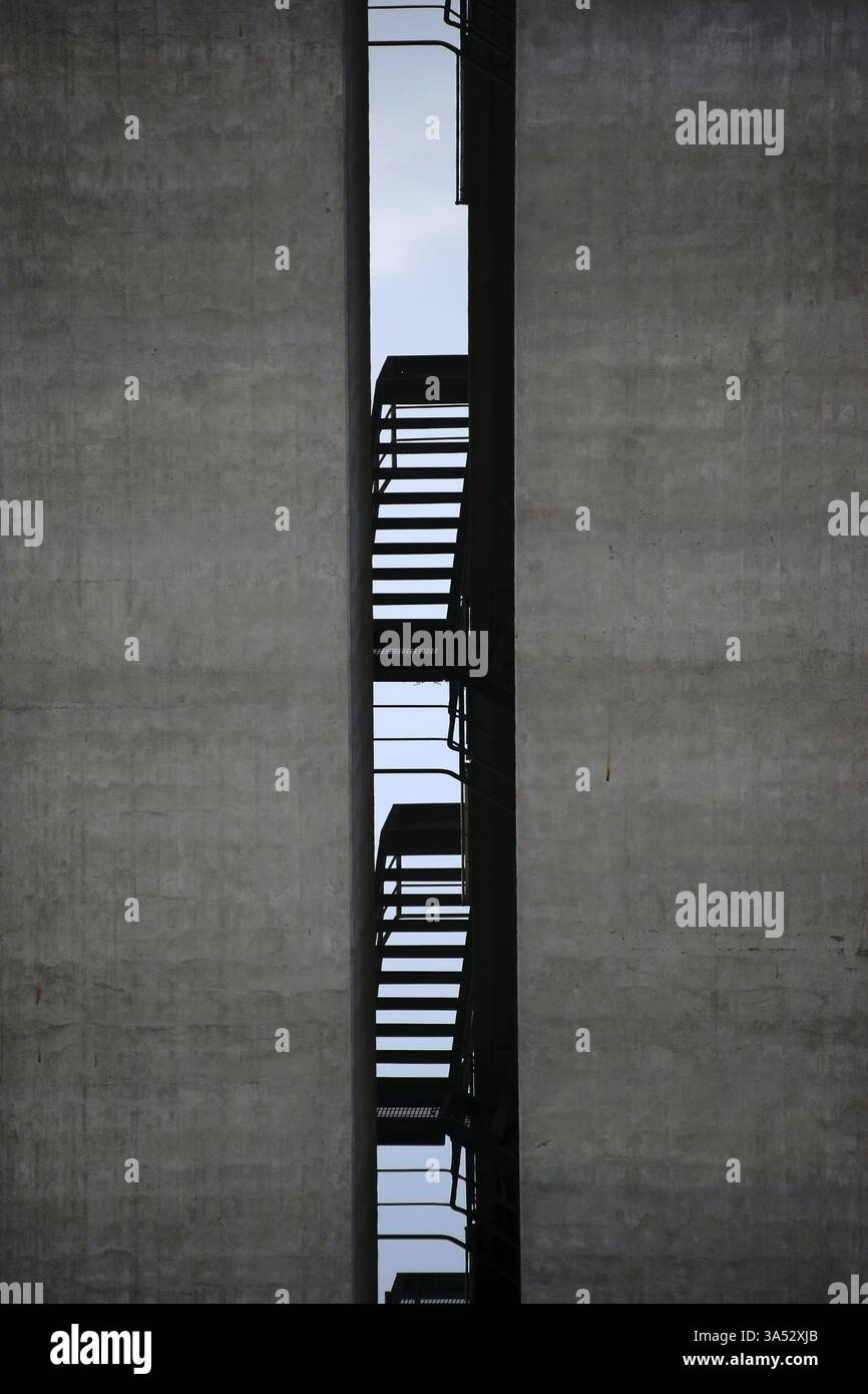 A staircase between two striking concrete industrial buildings Stock ...