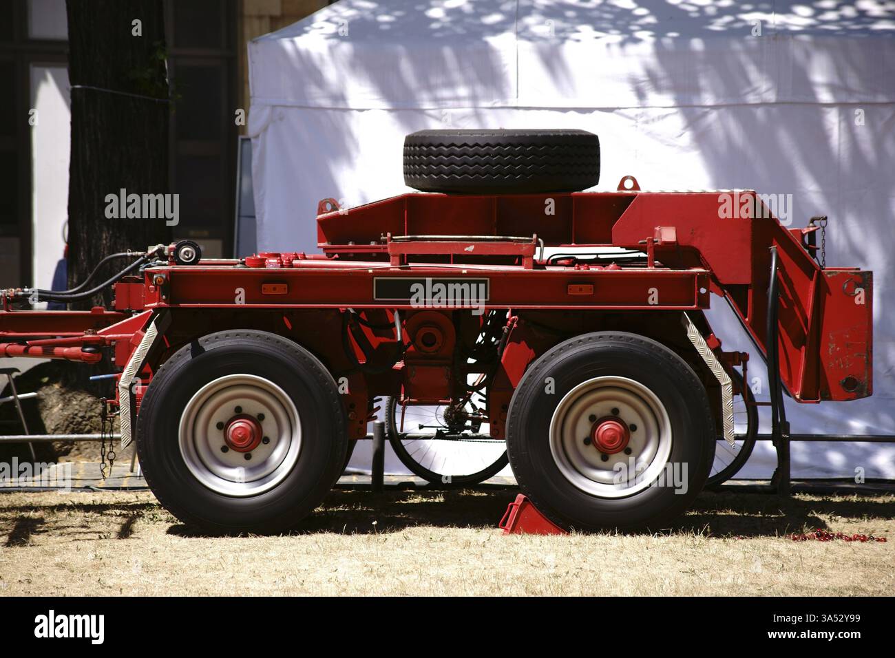 The bright red trailer of an articulated lorry with a spare wheel Stock ...