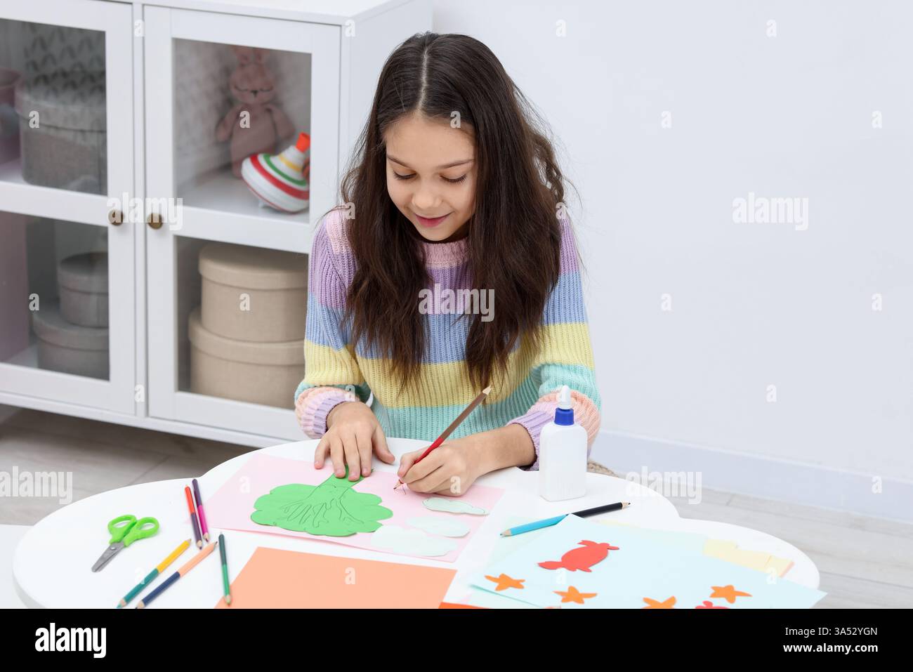 Girl drawing card at table indoors. Art and craft Stock Photo - Alamy