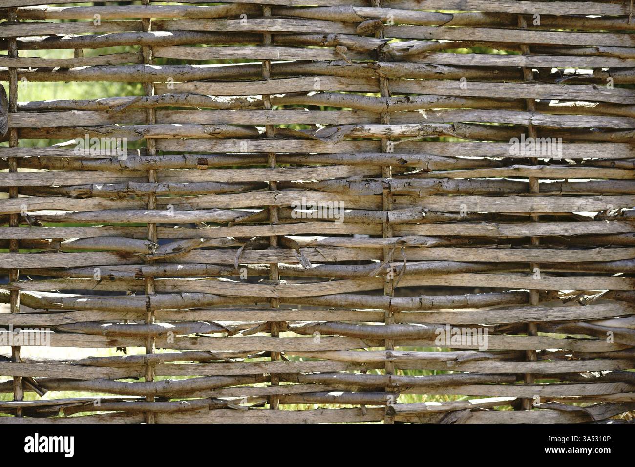 A homemade garden fence made from woven willow branches Stock Photo - Alamy