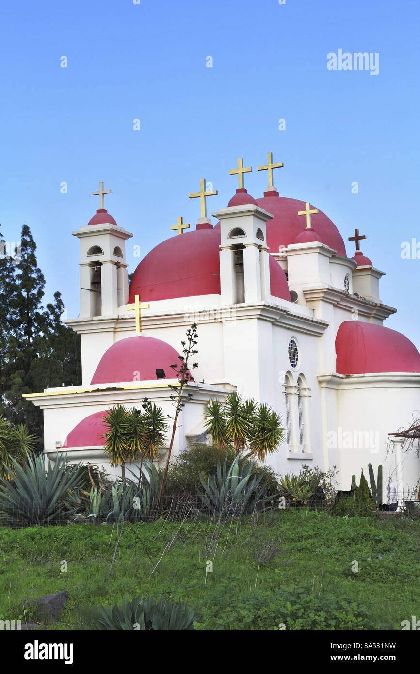 Bright pink dome, whitewashed walls of the holy temple on the shore of ...