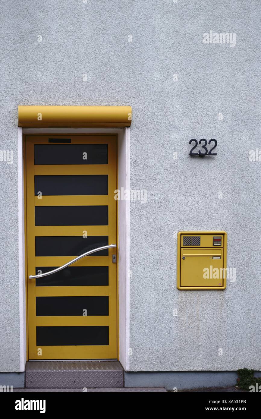 The modern front door of a residential building with a curved stainless ...