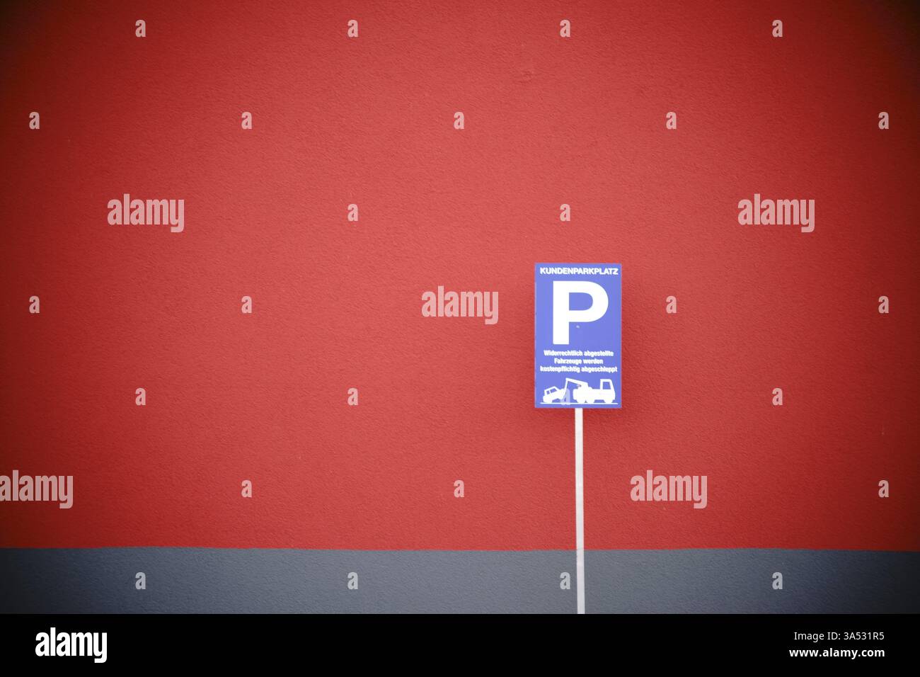 A parking sign and warning sign for unauthorised parking on a prominent ...