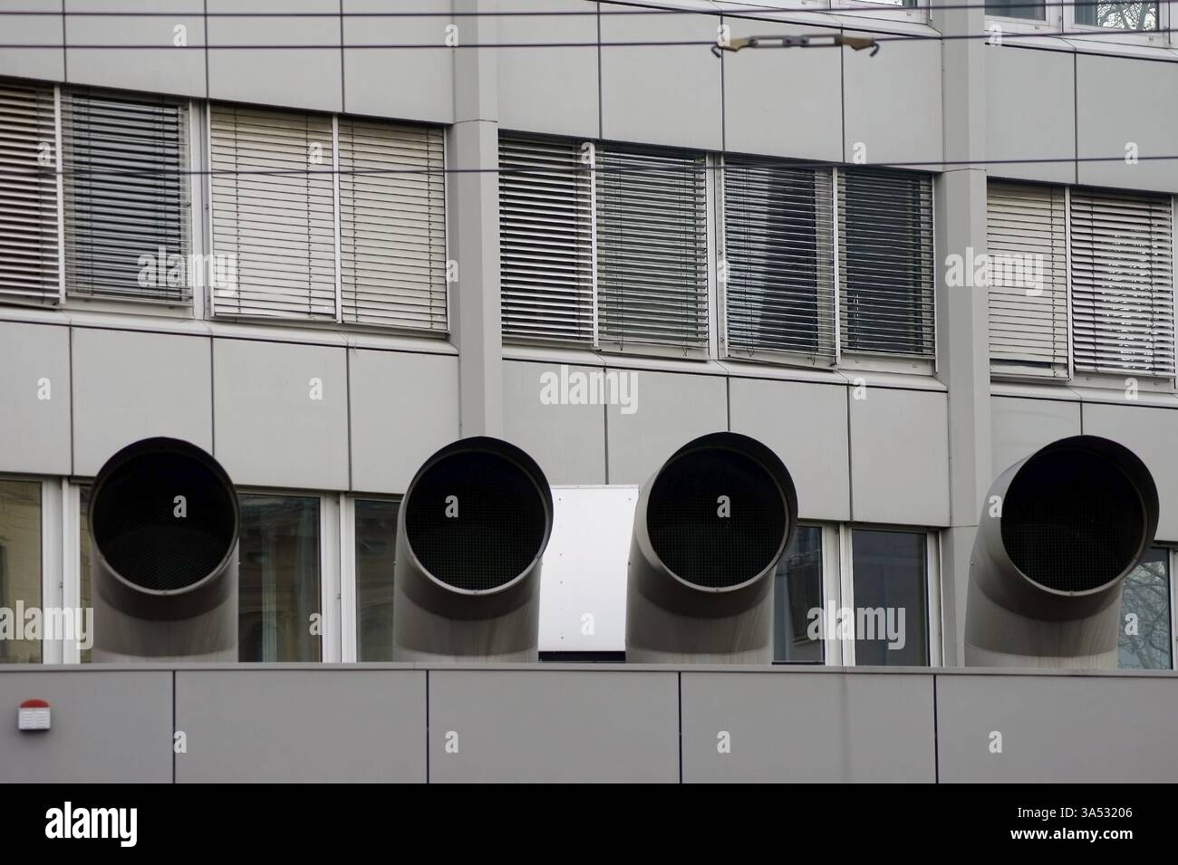 Four large ventilation pipes on a roof edge with an alarm system Stock ...