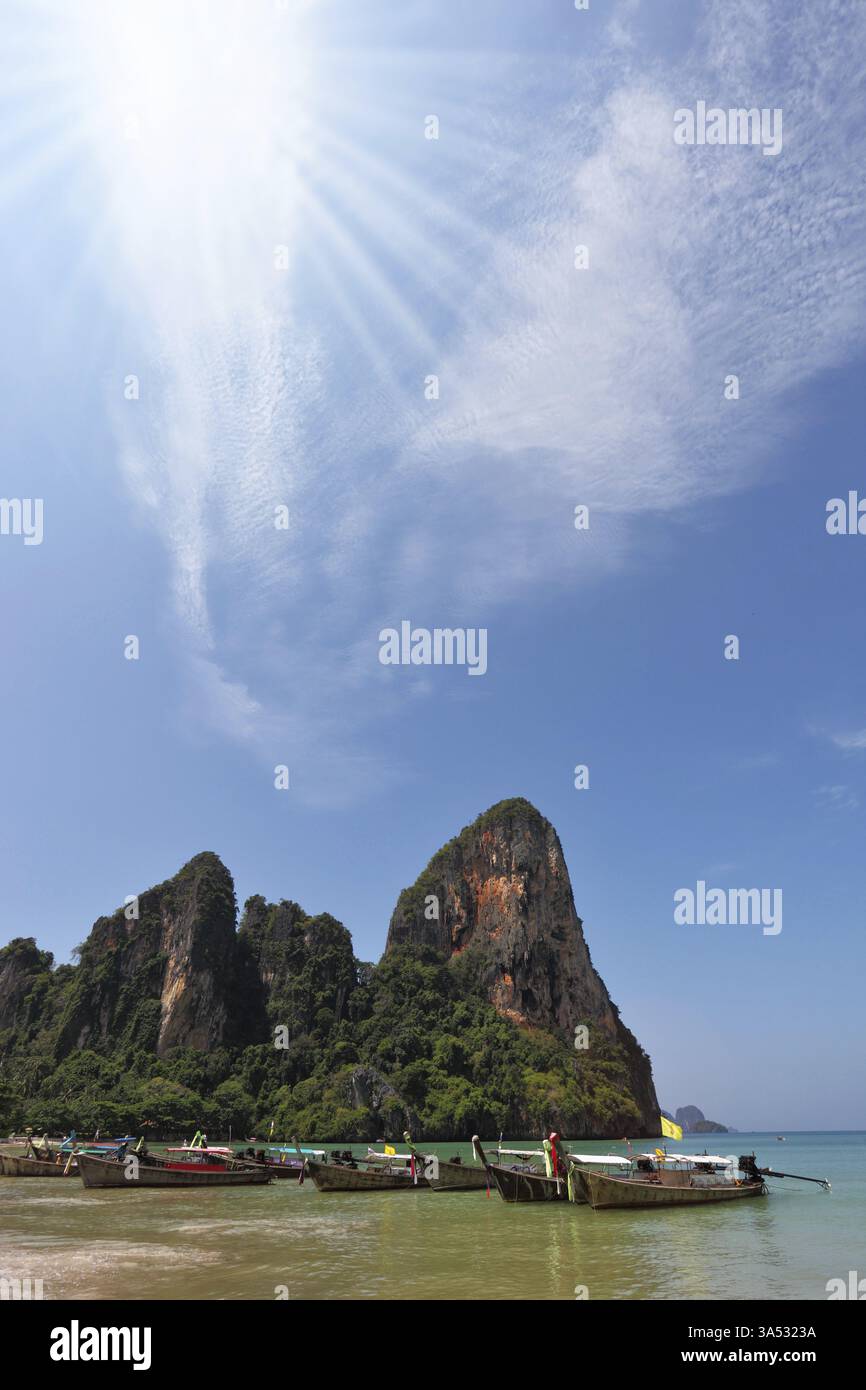 Light cirrus clouds over the warm sea. Picturesque native boat Longtail ...