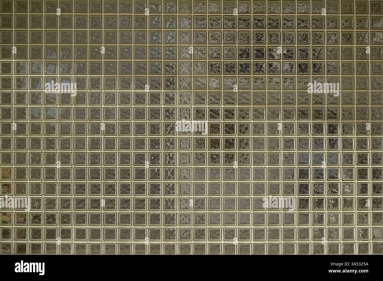 Close-up of a wall made of glass tiles with a semi-permeable surface ...