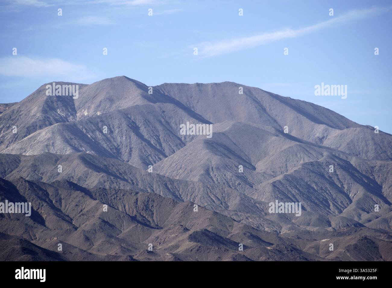 The portrait of a mountain with different and dark rock layers and ...