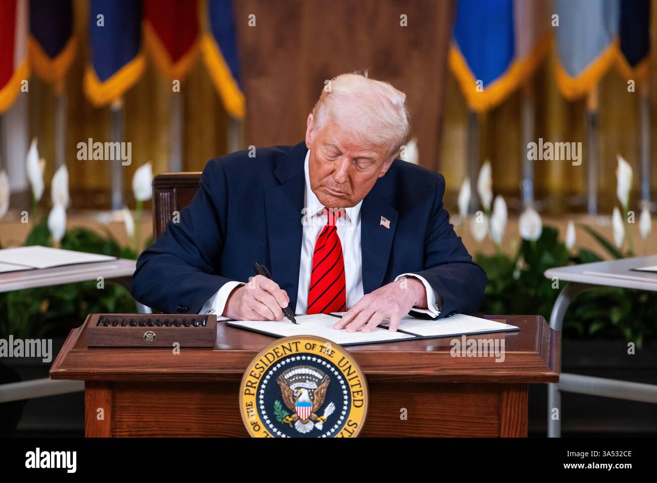 US President Donald Trump signs an executive order aimed at downsizing ...