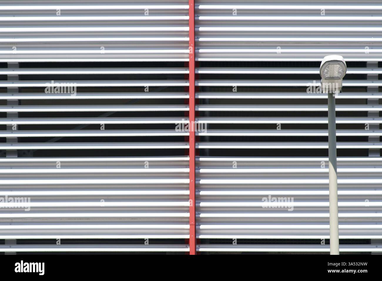 A street lamp in front of the modern sheet metal cladding of a multi ...