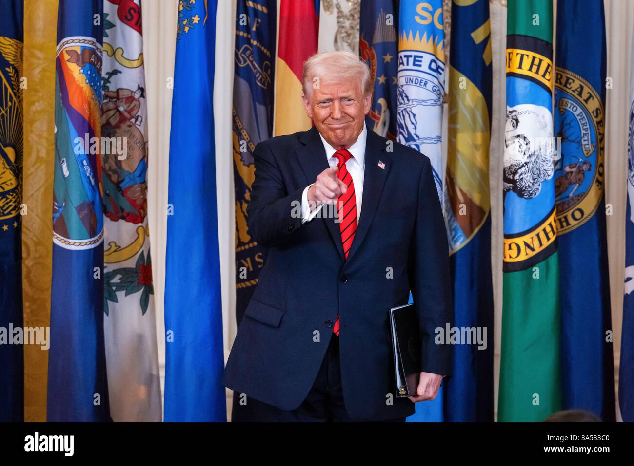 US President Donald Trump prepares to sign an executive order aimed at ...
