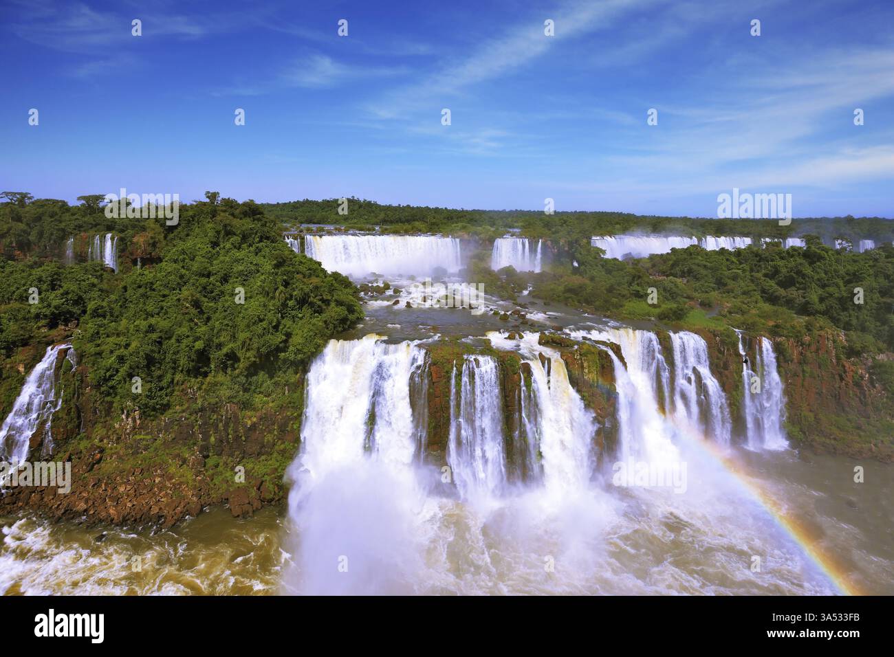 Roaring falls in South America - Iguazu. Foamy streams fall between the ...