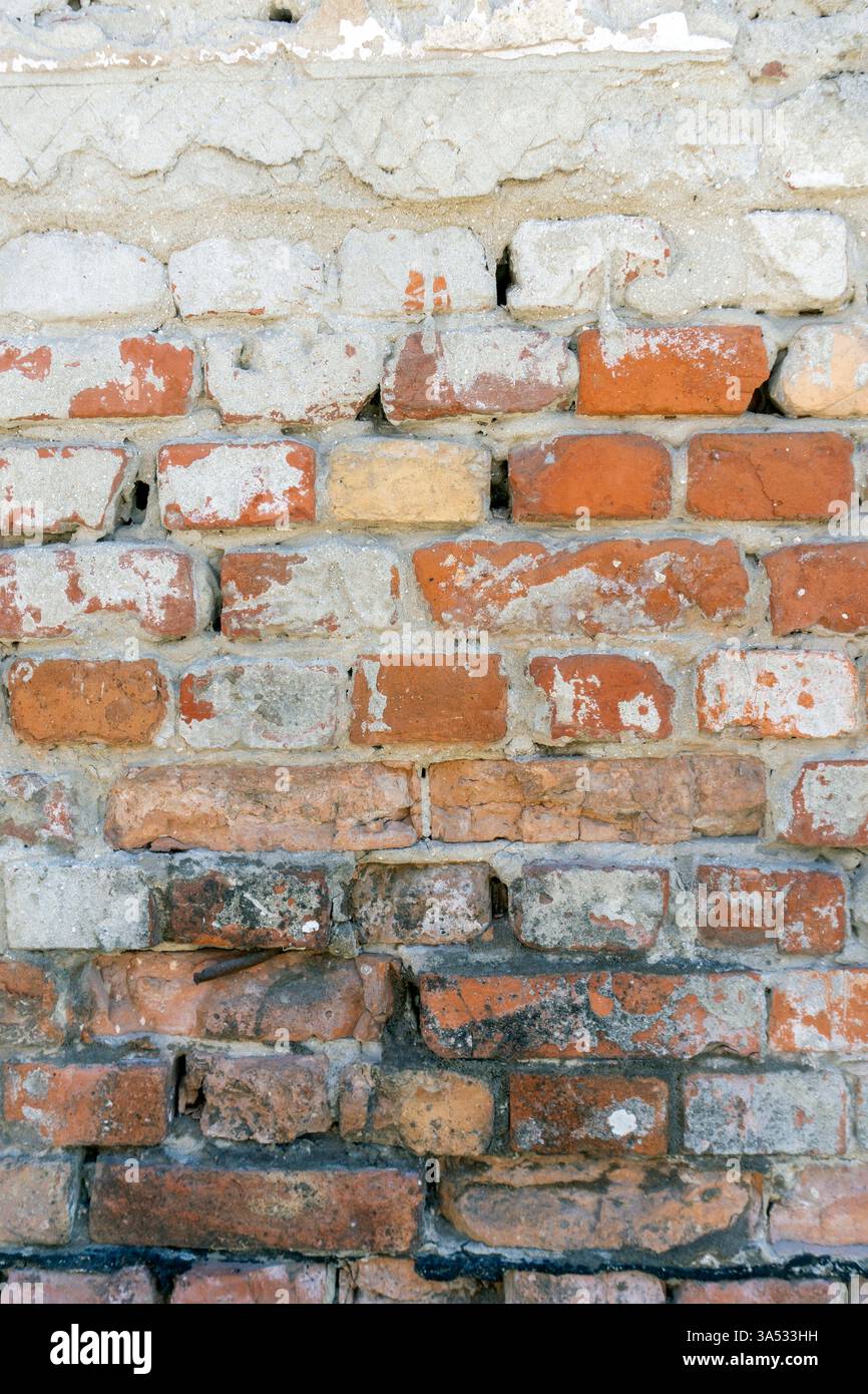 The wall displays a unique combination of weathered red and gray bricks ...