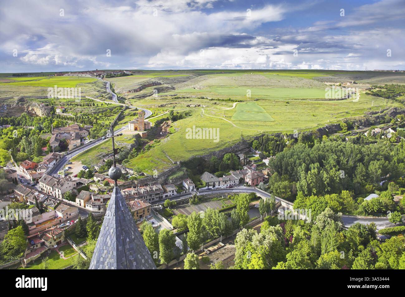 Roof and spik medieval palace on a background green spring a field and ...